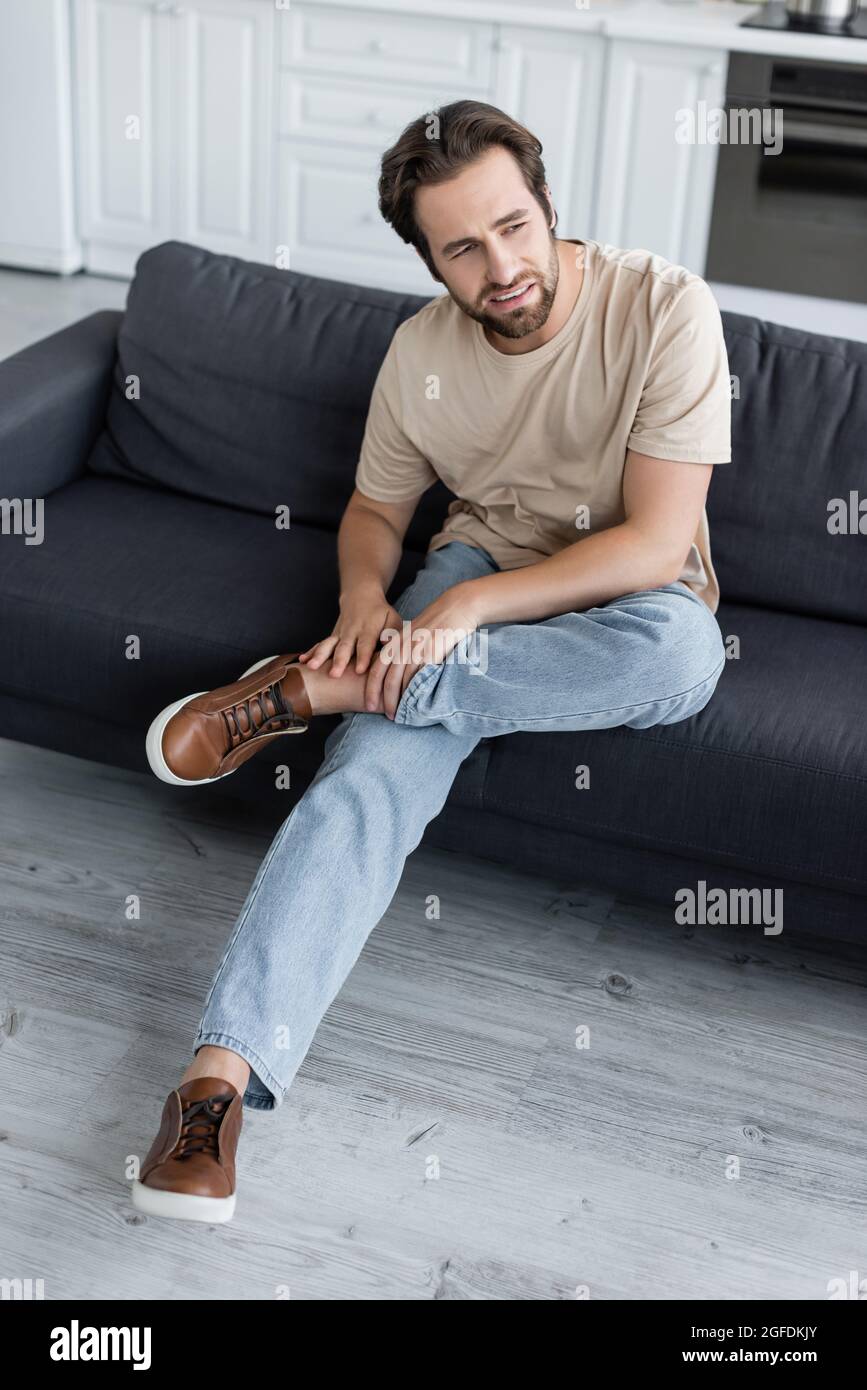 Man touching leg hi-res stock photography and images - Alamy