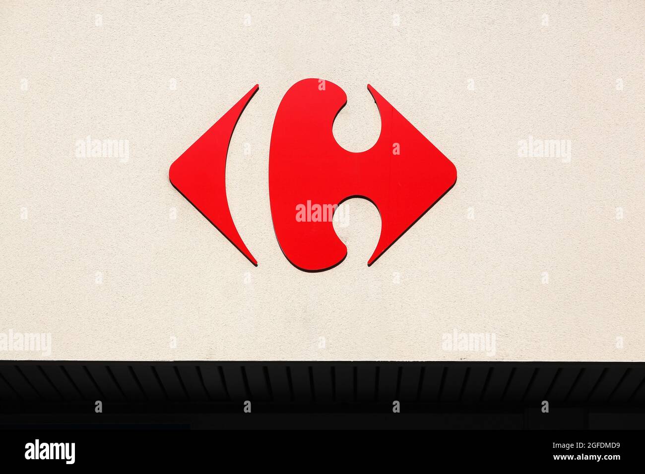 Anse, France - July 17, 2021: Carrefour sign on a wall. Carrefour is a ...