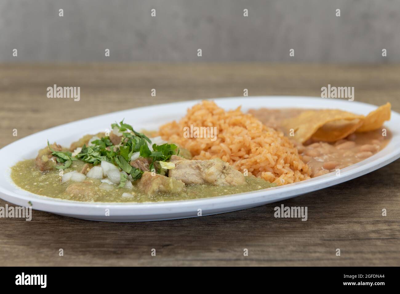 Hearty plate of chili verde smothered in green sauce served with rice ...