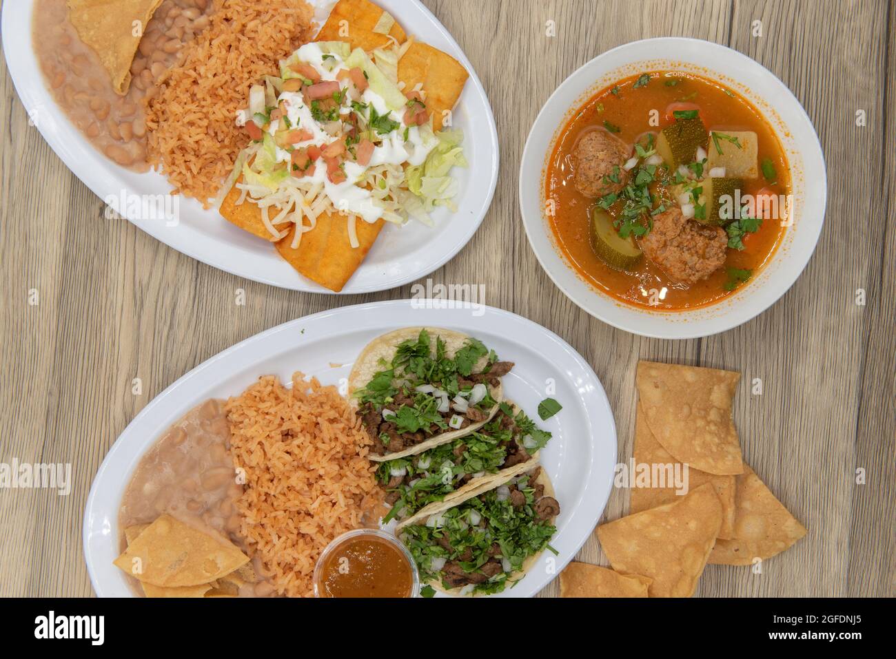 Table of Mexican Buffet with tacos enchiladas chalupas and tamales on a ...