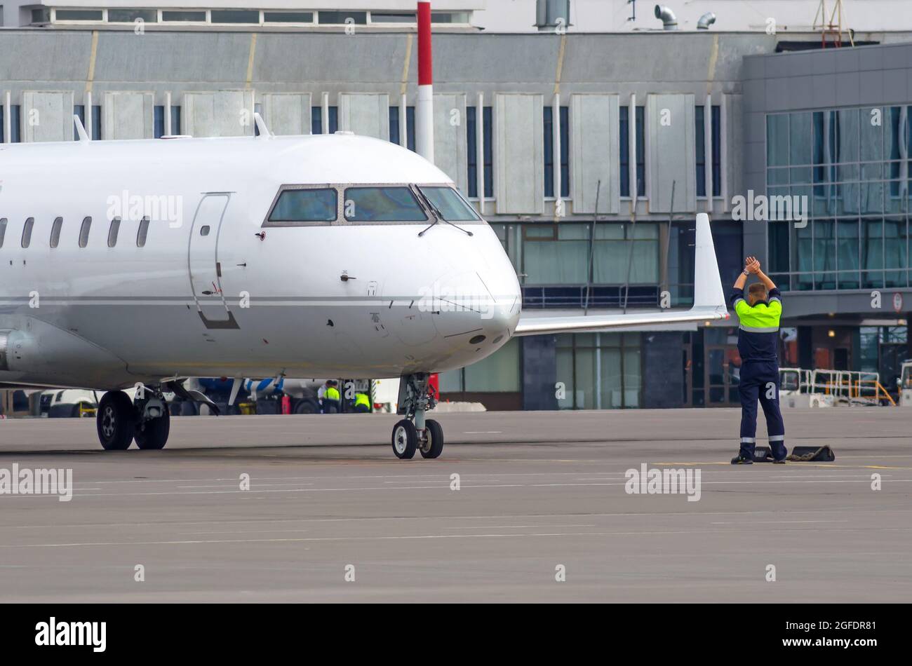 Man guiding airplane hi-res stock photography and images - Alamy