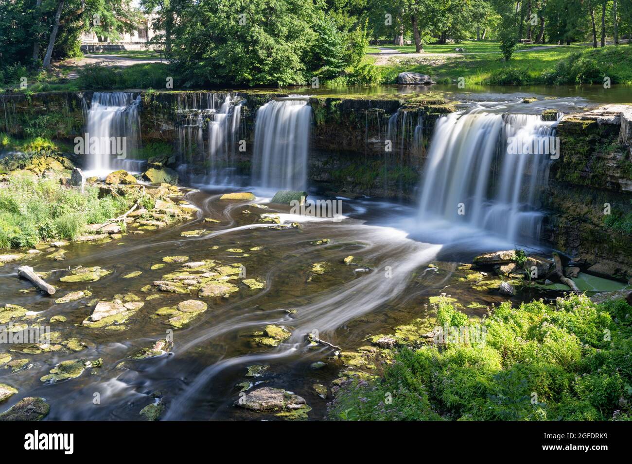 An idyllic river landscape in the forest with a waterfall Stock Photo ...