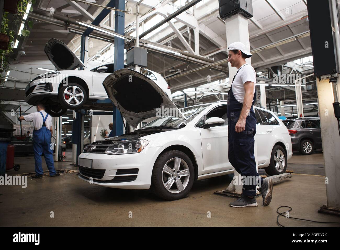 Professional car service repairman working at the station Stock Photo ...