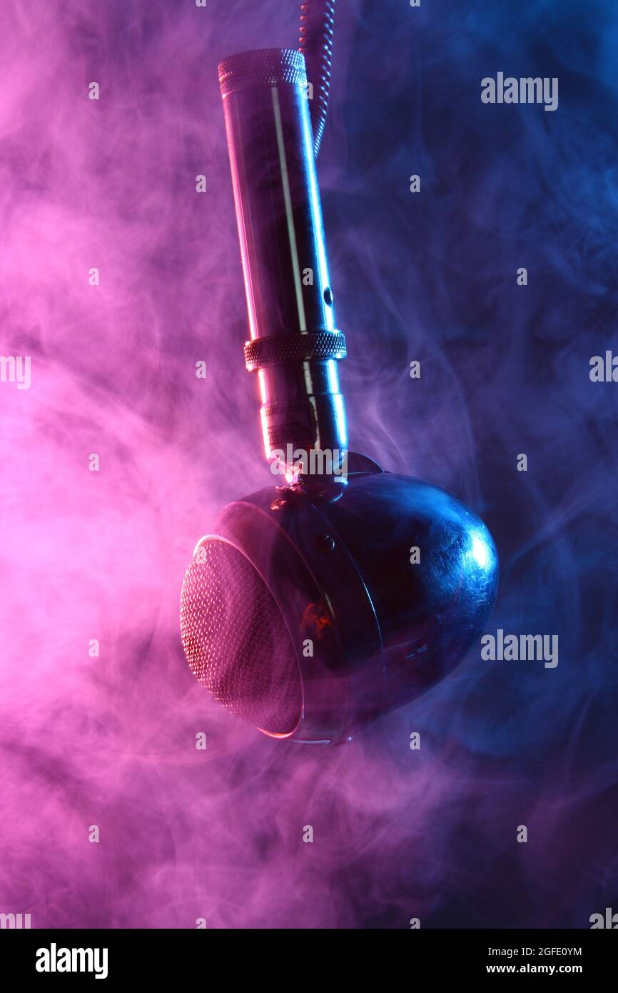 Old egg-shaped microphone surrounded by blue and pink smoke Stock Photo ...