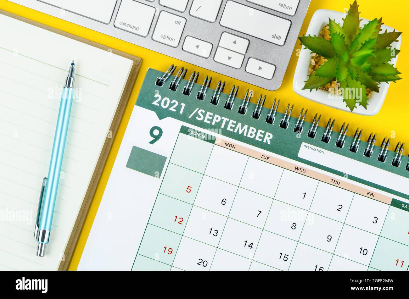 September 2021 desk calendar and diary with keyboard computer on yellow ...