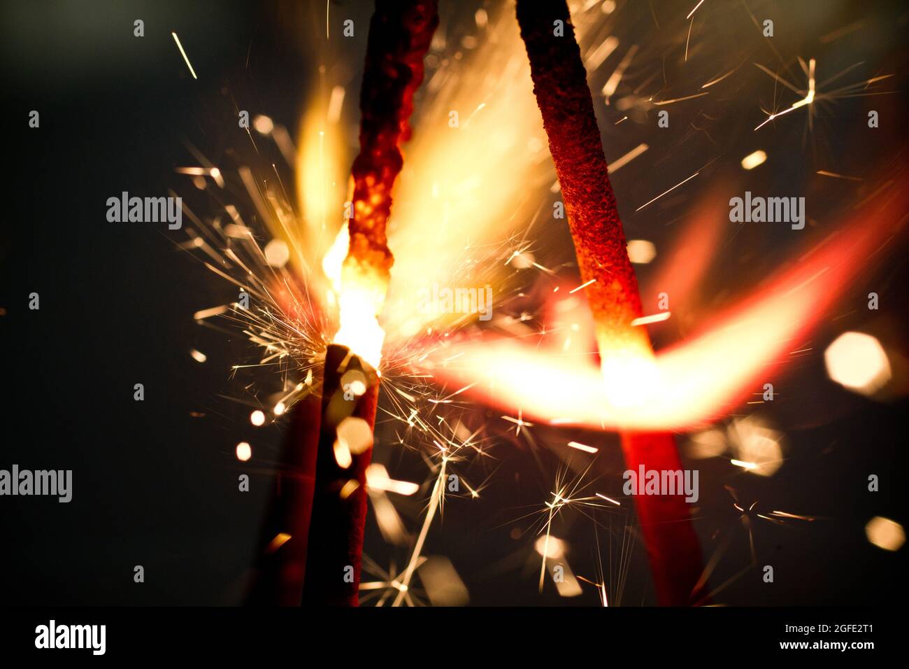 Lit sparklers letting off a shower of sparks and flares Stock Photo - Alamy