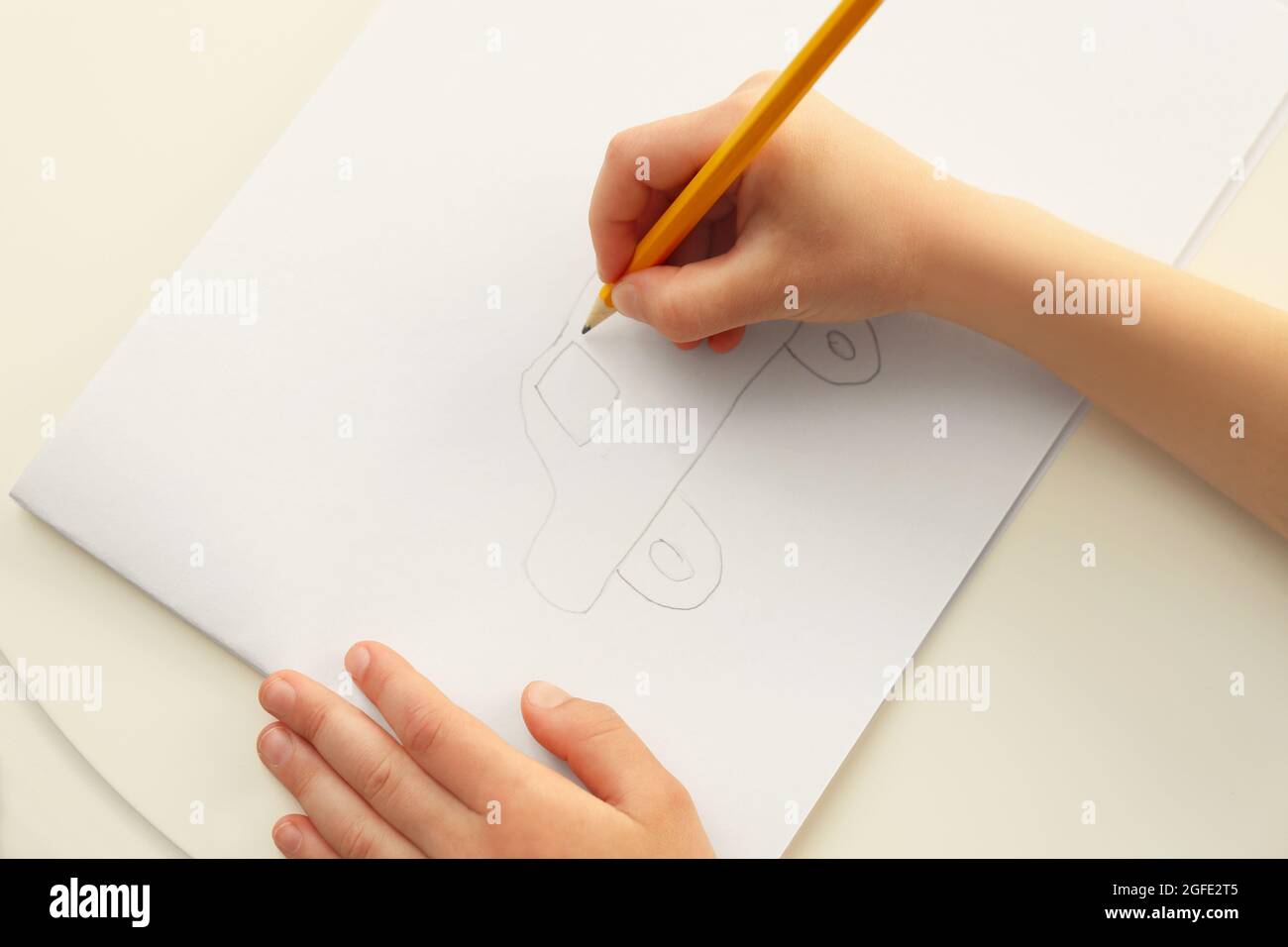 Child's hand drawing picture on paper Stock Photo - Alamy