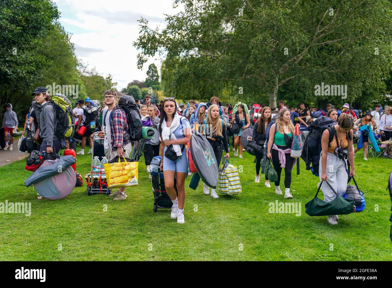 Festival goers walk along the towpath of the River Thames as they ...
