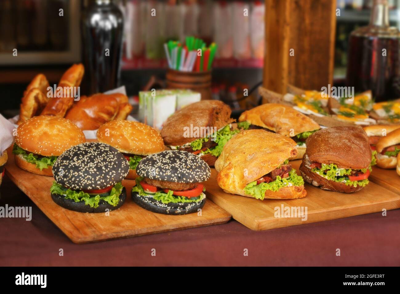 Wooden cutting boards with different burgers on counter Stock Photo - Alamy