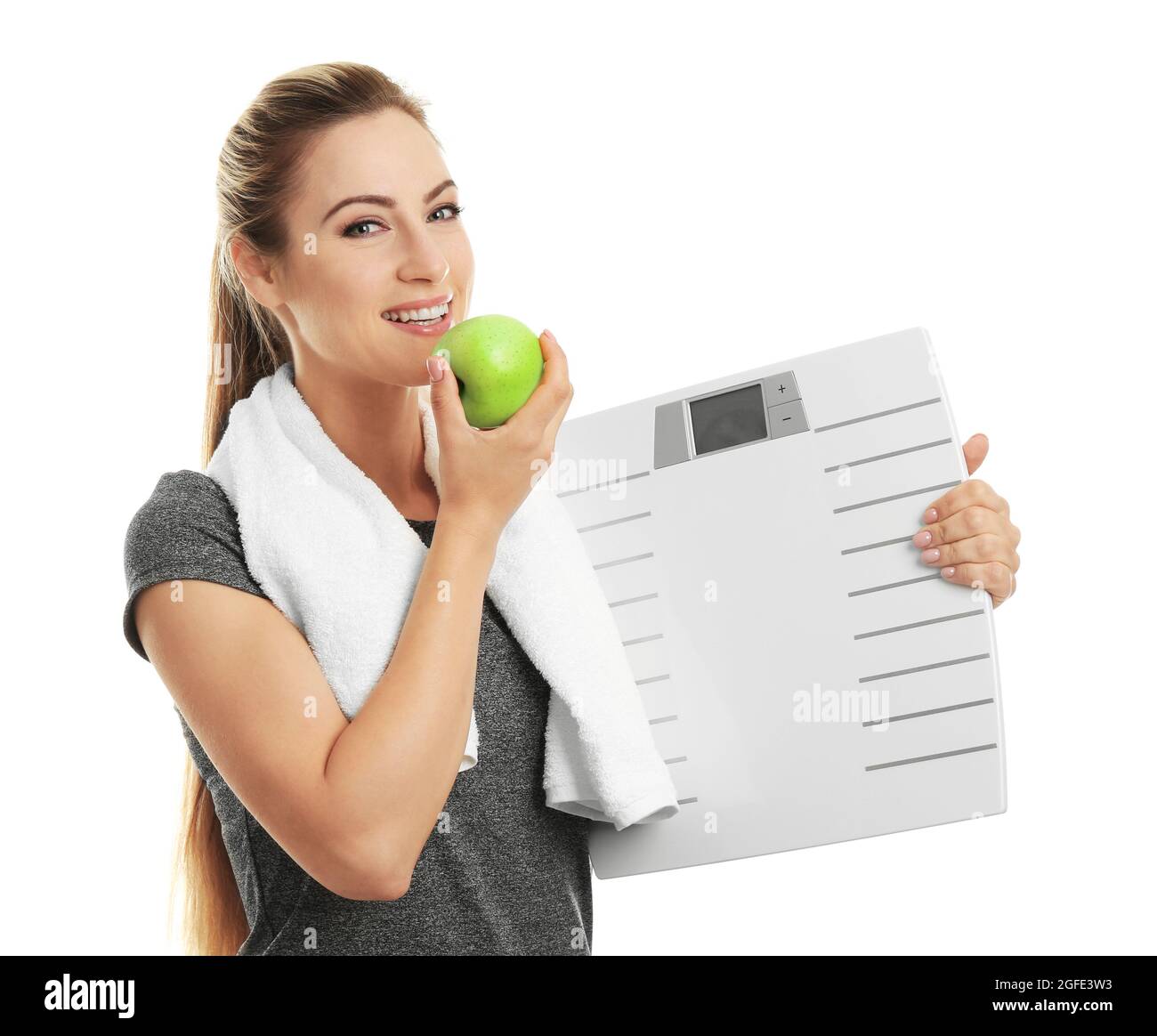 Beautiful young woman holding floor scales on white background Stock ...