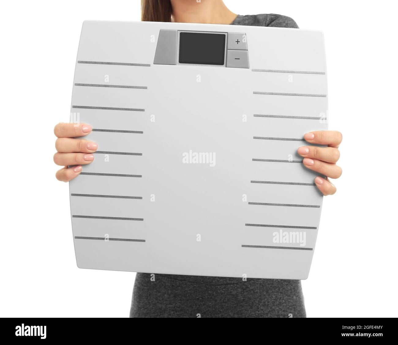 Beautiful young woman holding floor scales on white background Stock ...