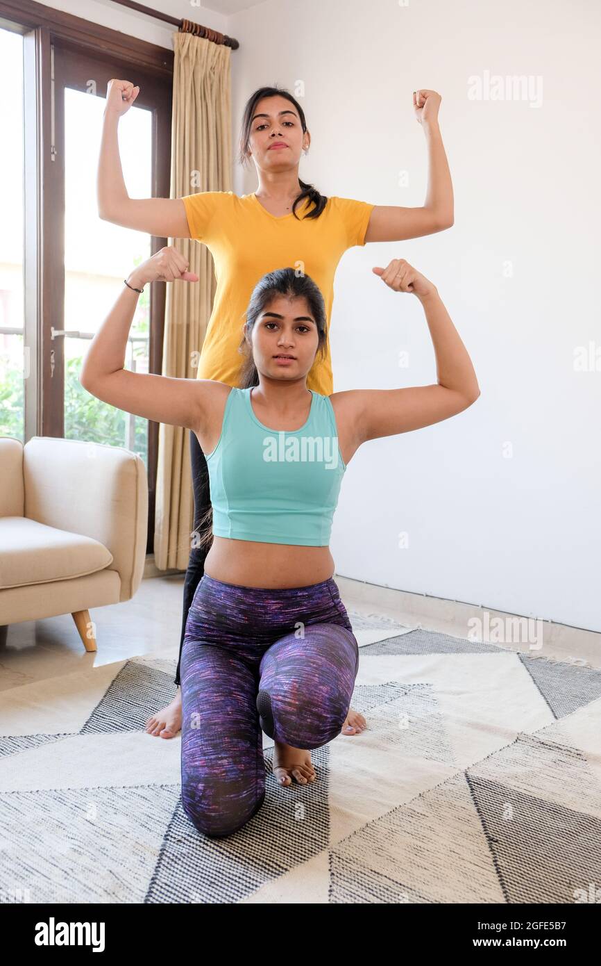 Vertical closeup of two girls training at home Stock Photo - Alamy