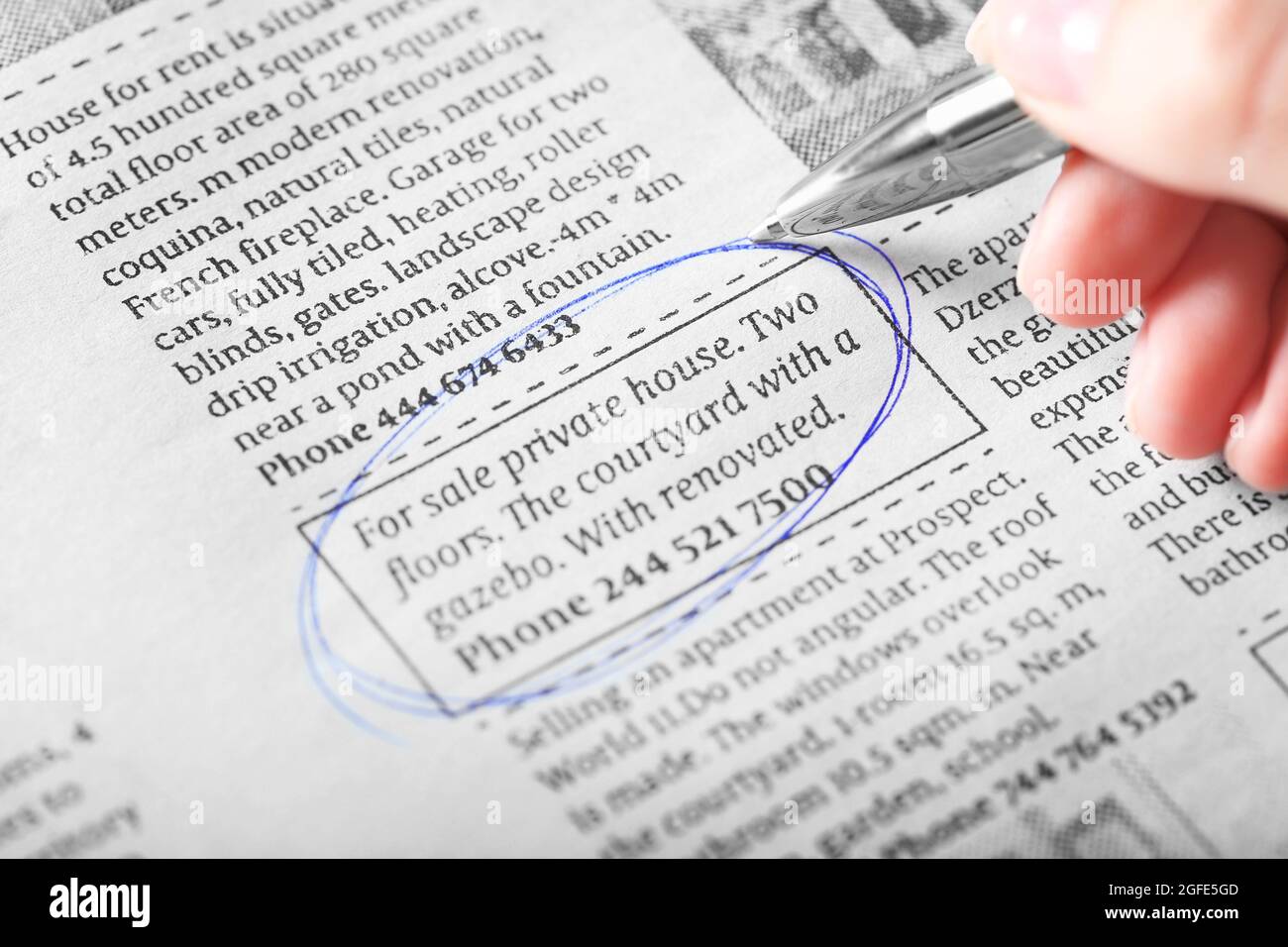 Search newspaper advertisements for information Stock Photo - Alamy