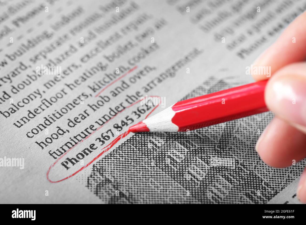 Search newspaper advertisements for information Stock Photo - Alamy