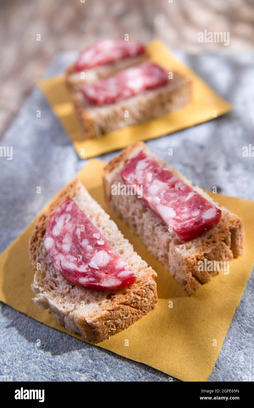 Presentation of a snack of bread and salami Stock Photo - Alamy