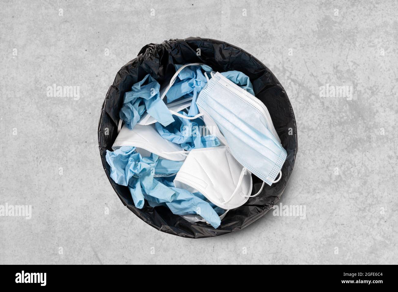 Trash can full of used face mask and protective gloves. Covid-19 ...