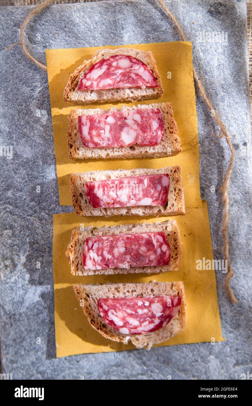 Presentation of a snack of bread and salami Stock Photo - Alamy