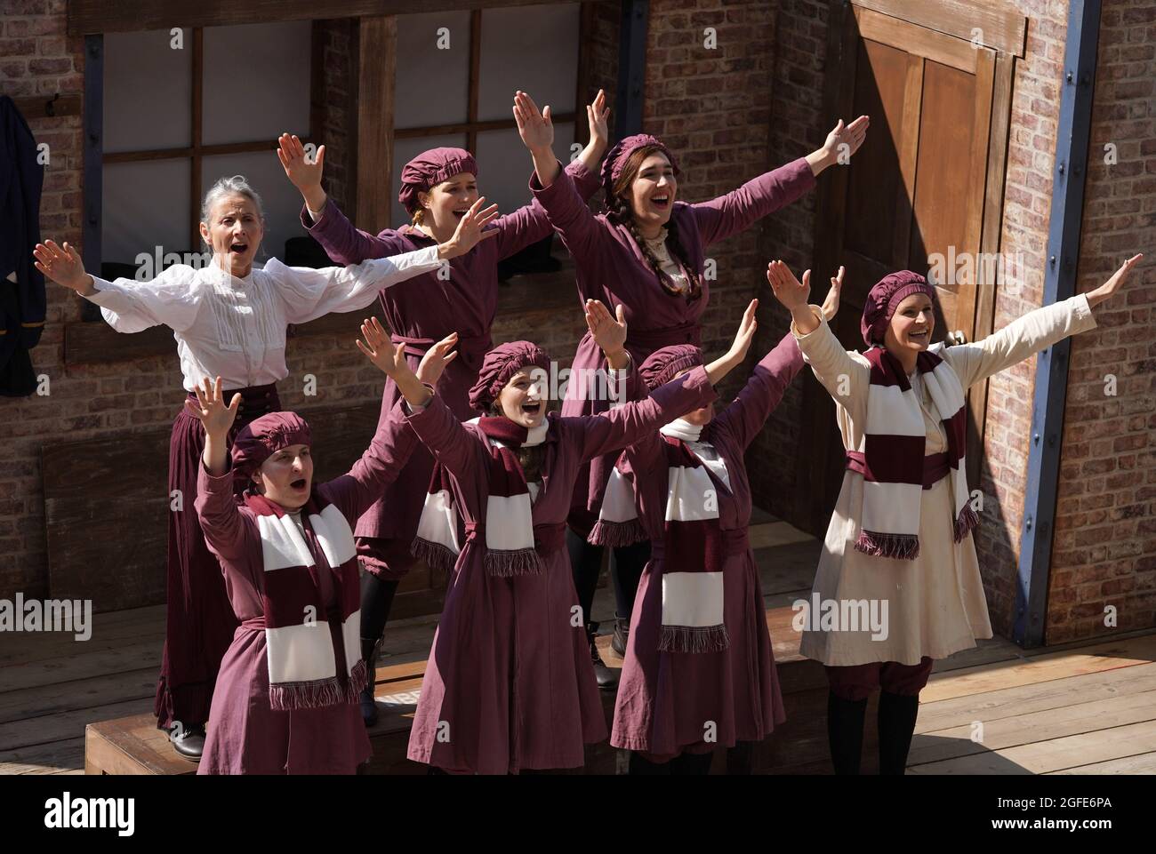 The cast of Sweet F.A. performing on a make shift stage in the stand at ...