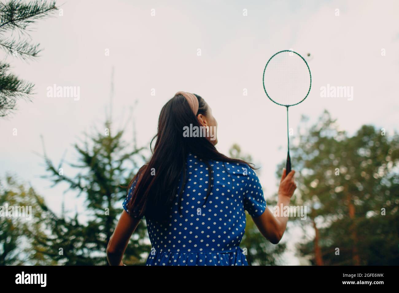 Young adult woman playing badminton in the park Stock Photo - Alamy