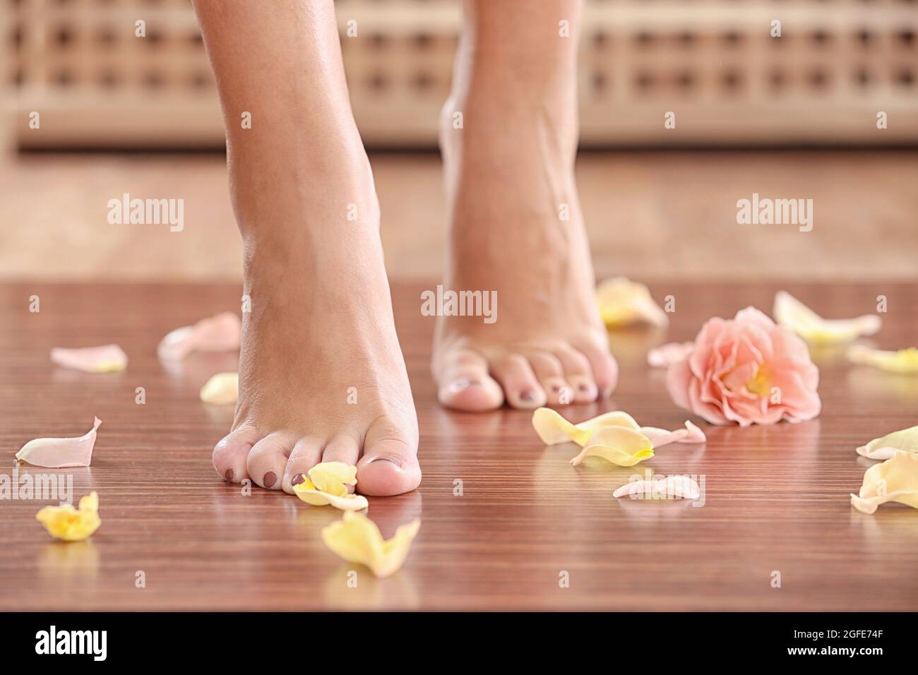 Female feet with flowers on floor Stock Photo - Alamy