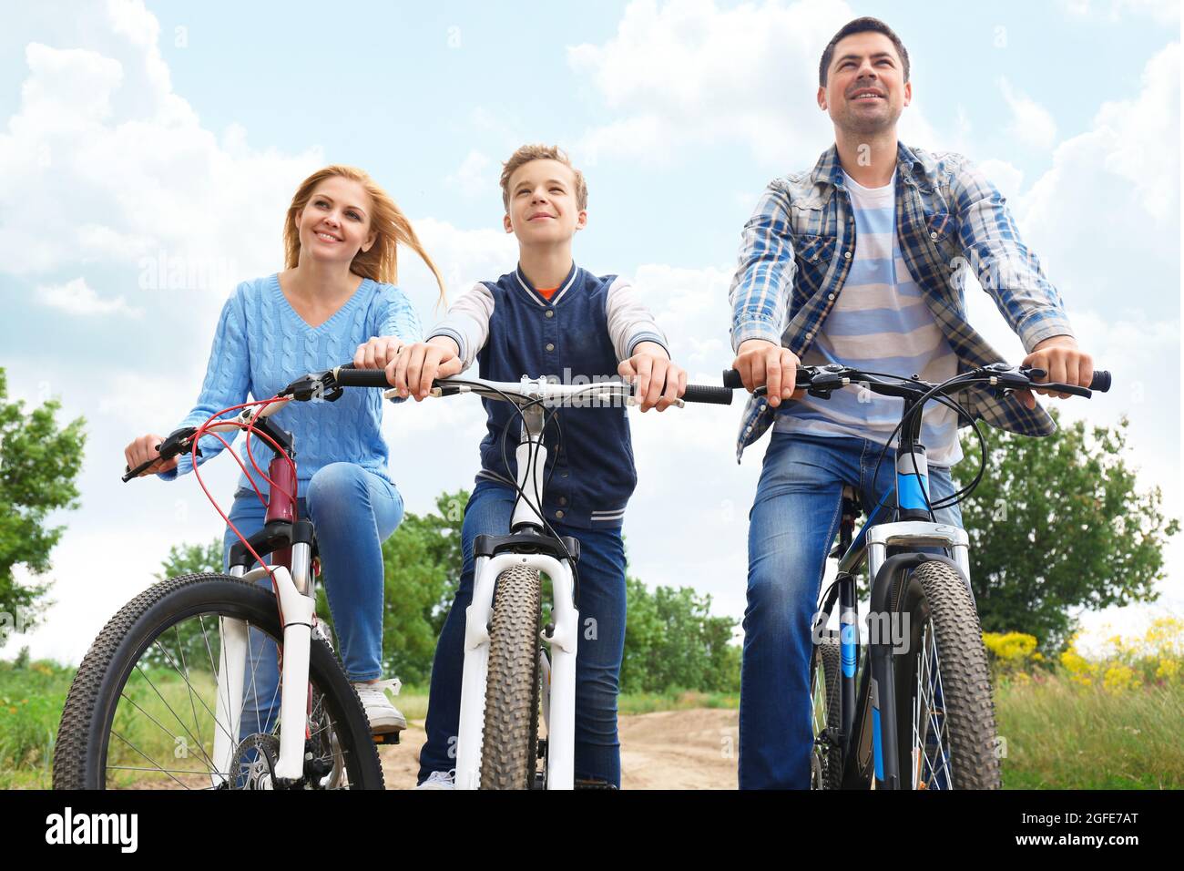 Happy family on bike ride Stock Photo - Alamy
