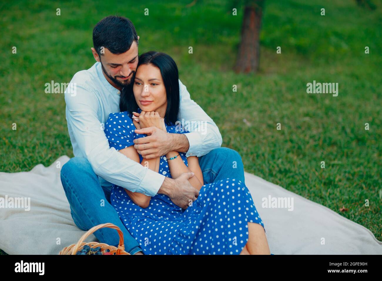 Young adult woman and man hugging couple picnic at green grass meadow in park Stock Photo - Alamy