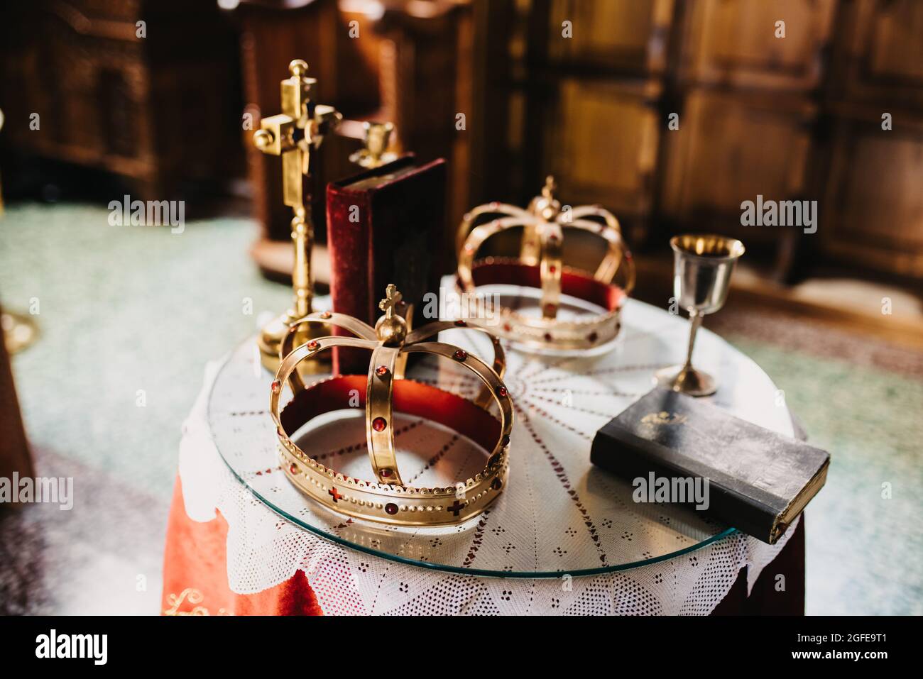 Traditional wedding crowns on the table in the church Stock Photo - Alamy
