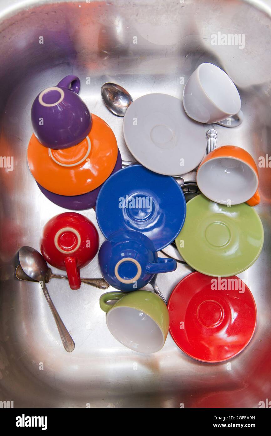 After dinner coffee cups to be washed in the sink Stock Photo - Alamy