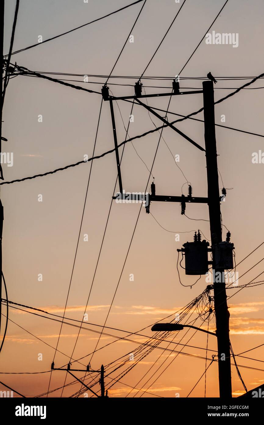Mess of wires during the sunset. Las Tunas, Cuba Stock Photo - Alamy
