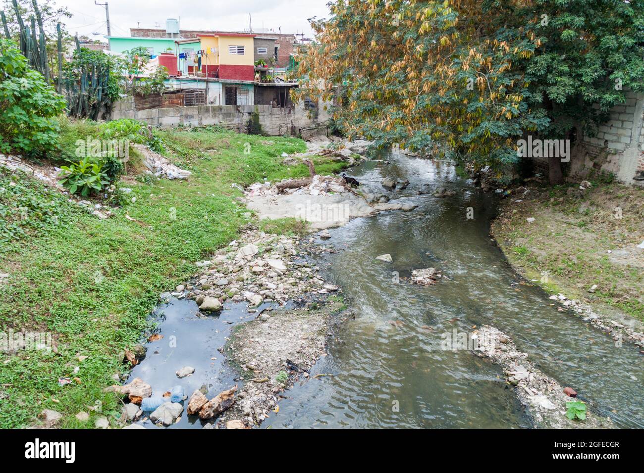 Small creek full of garbage in Holguin, Cuba Stock Photo - Alamy