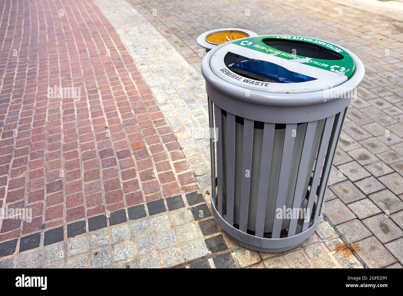 Outdoor public garbage bin with compartments for general and recycling ...