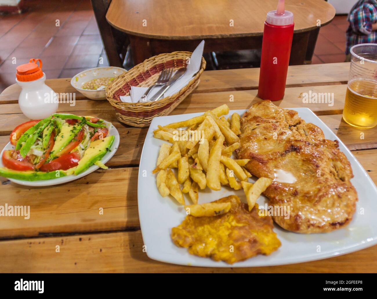 Chicken steak in a restaurant in Colombia. Accompanied by french fries ...
