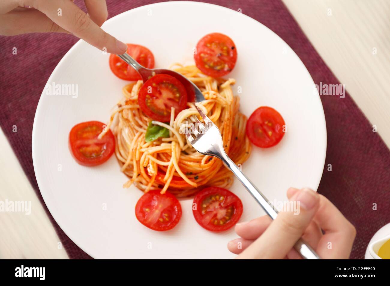 Woman eating delicious pasta in restaurant Stock Photo - Alamy