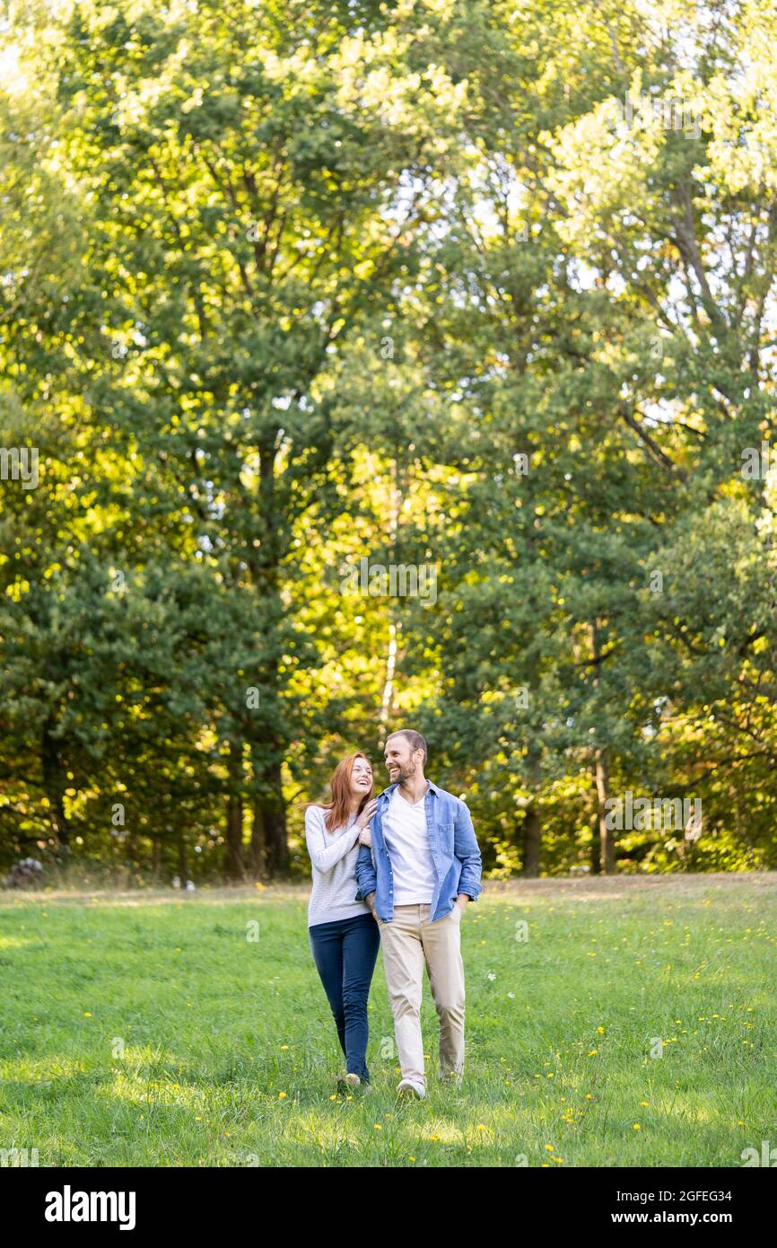 Walking smiling looking away hands in pockets hi-res stock photography ...