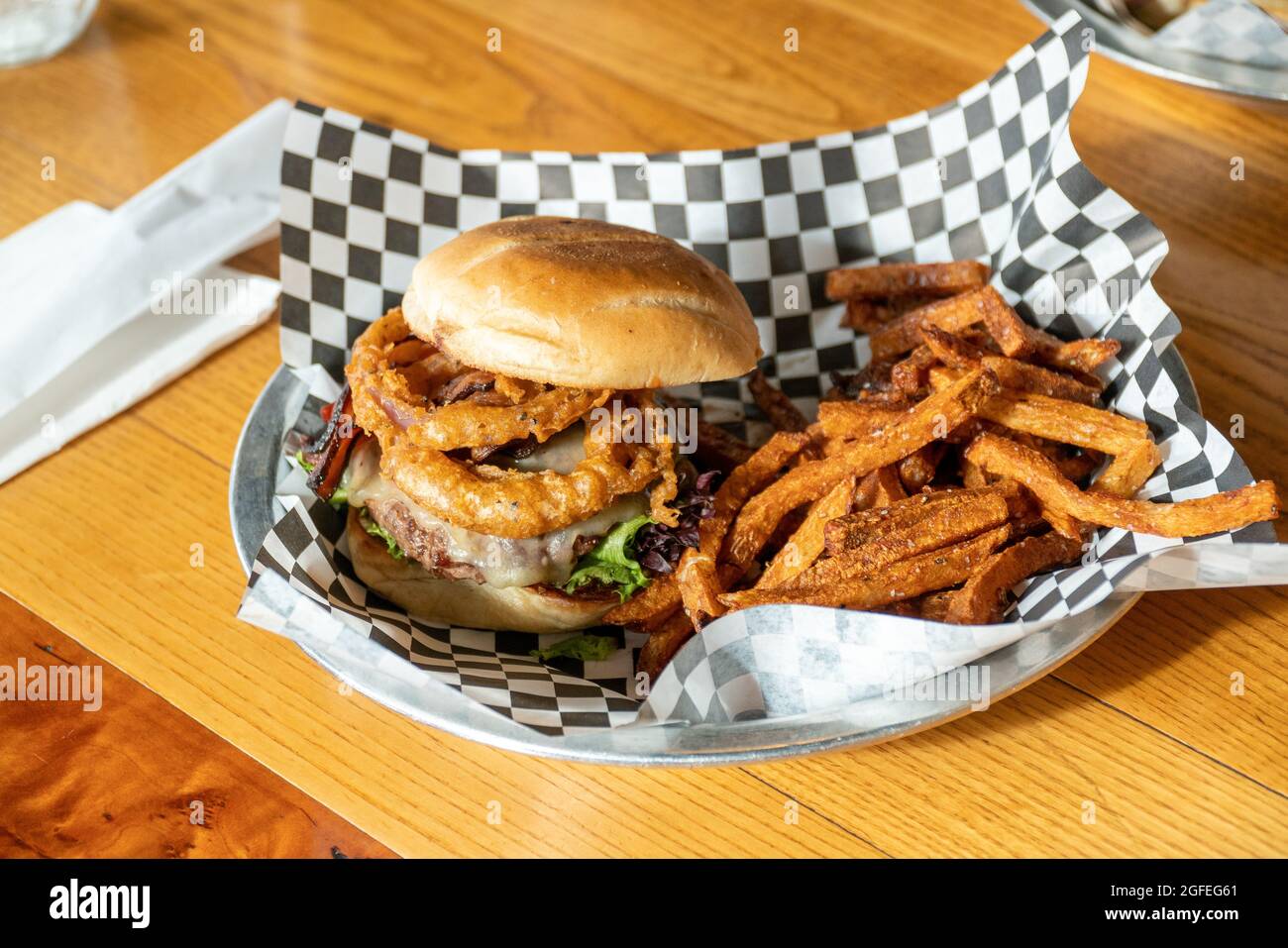 Gourmet BBQ Onion Ring Hamburger With Fries Stock Photo - Alamy