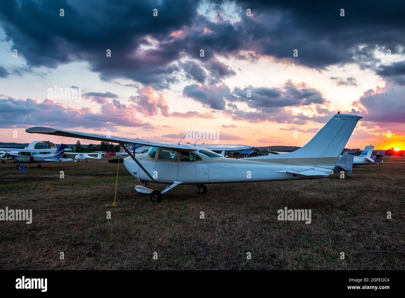 Small private airplanes parked at the airfield at scenic sunset Stock ...
