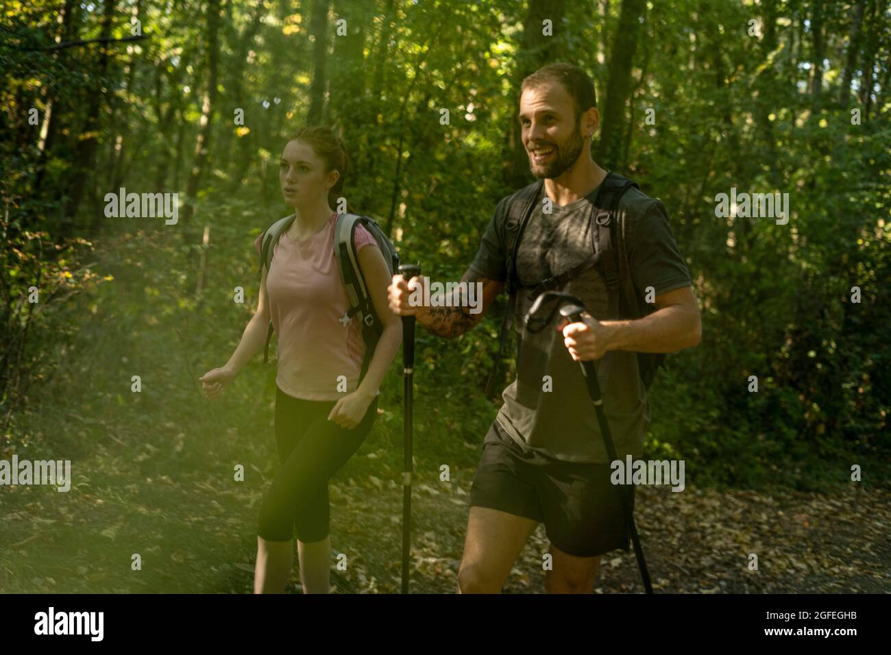Young men trekking poles hi-res stock photography and images - Alamy