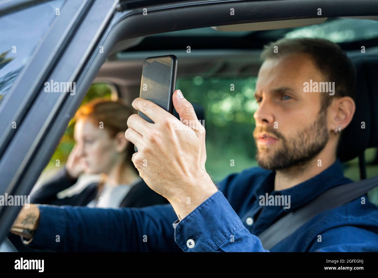 People using their phones while driving hi-res stock photography and ...