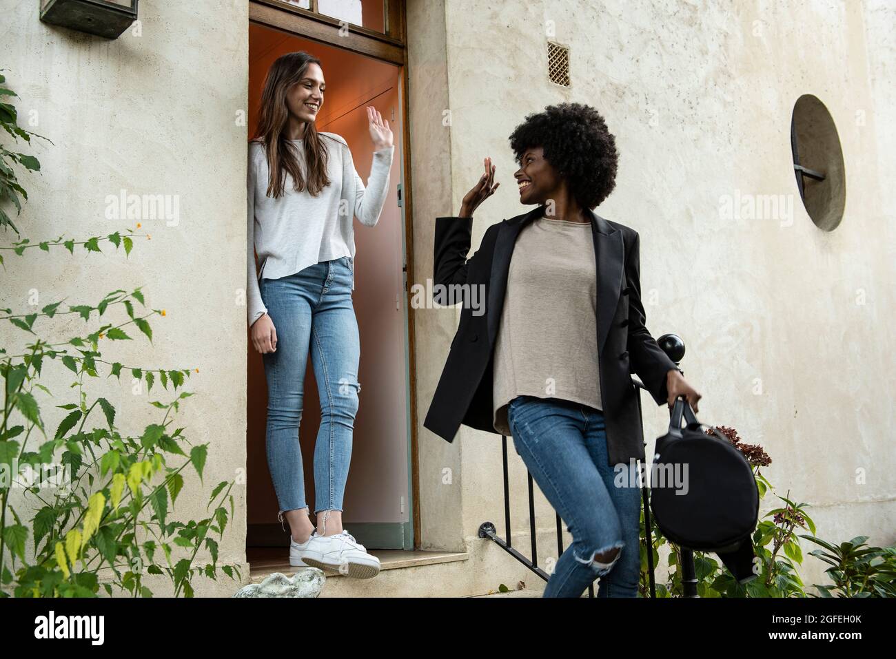 Woman doorstep waving hi-res stock photography and images - Alamy