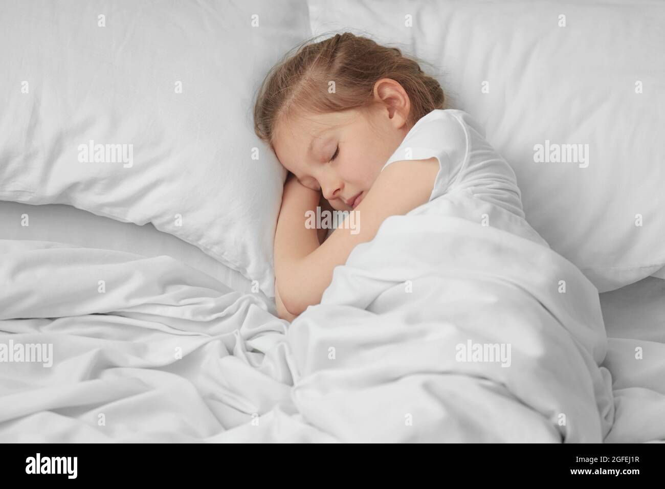 Cute sleeping girl in white bed Stock Photo - Alamy