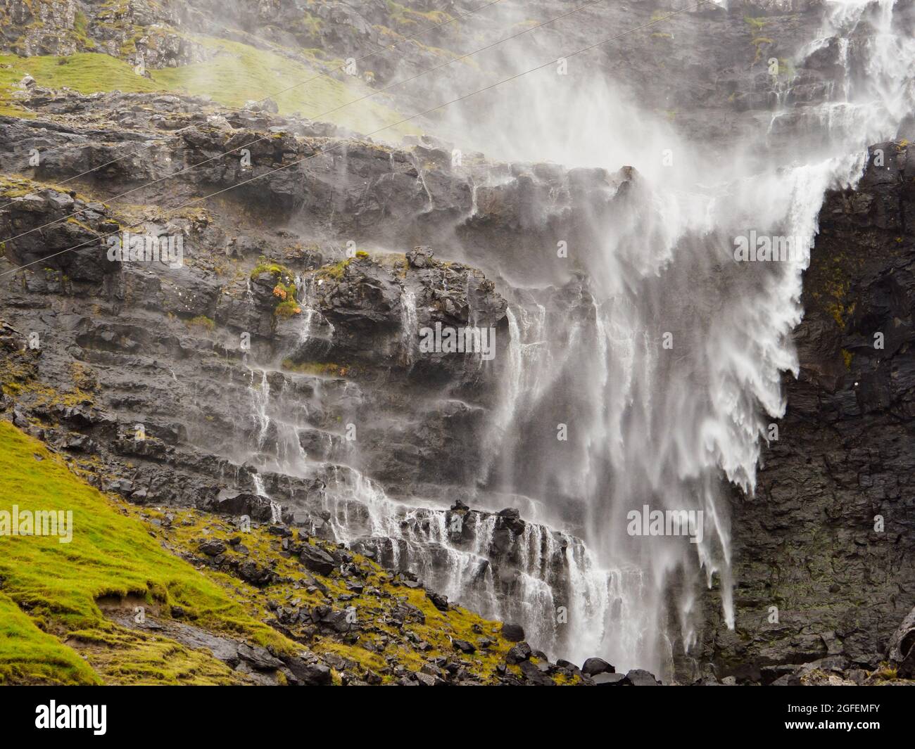 Waterfall Fossa (Fossá) during strong wind in rainy weather, Streymoy ...