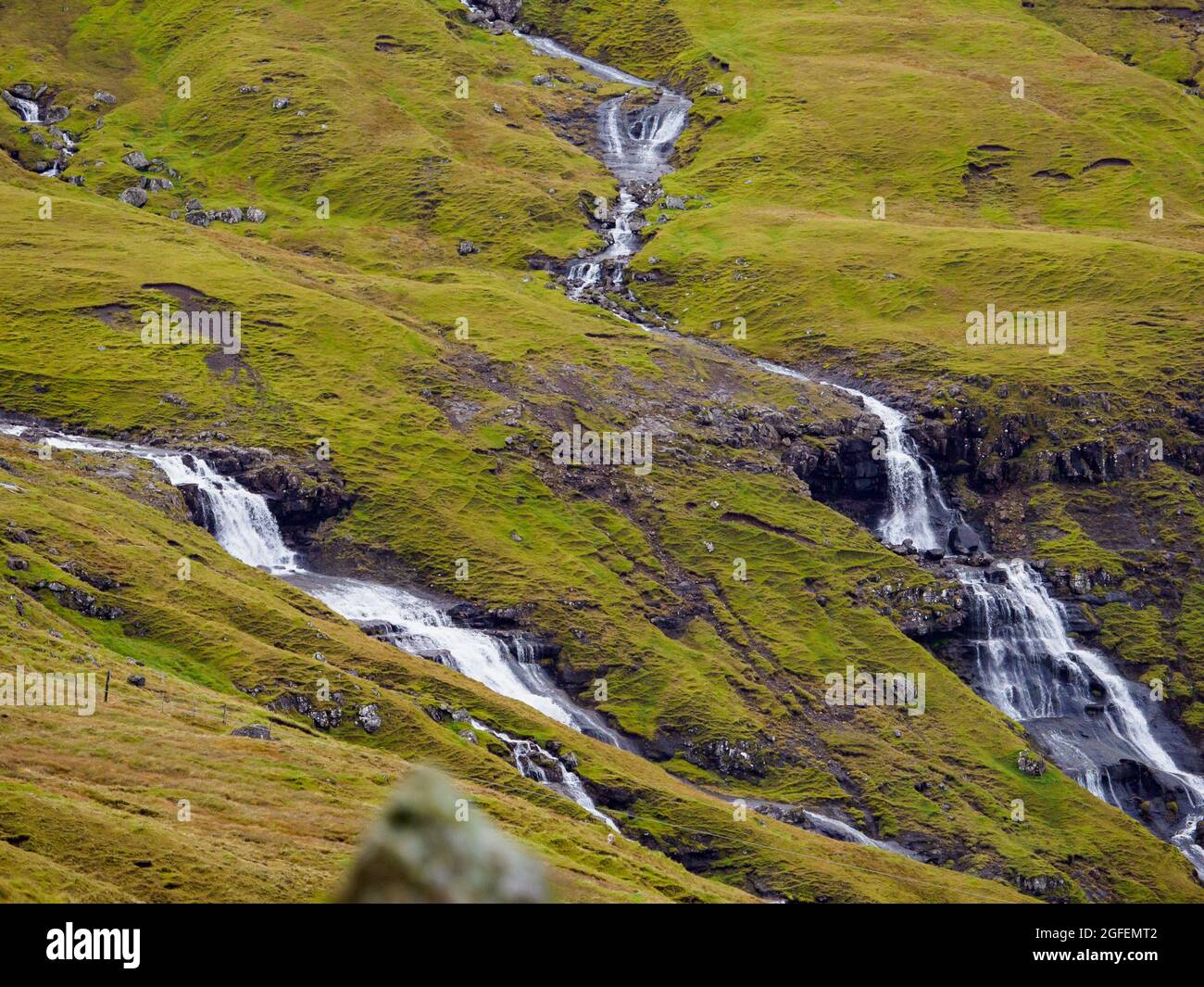 Dozens of small rivulets flowing down the rocks after a rainy day in ...