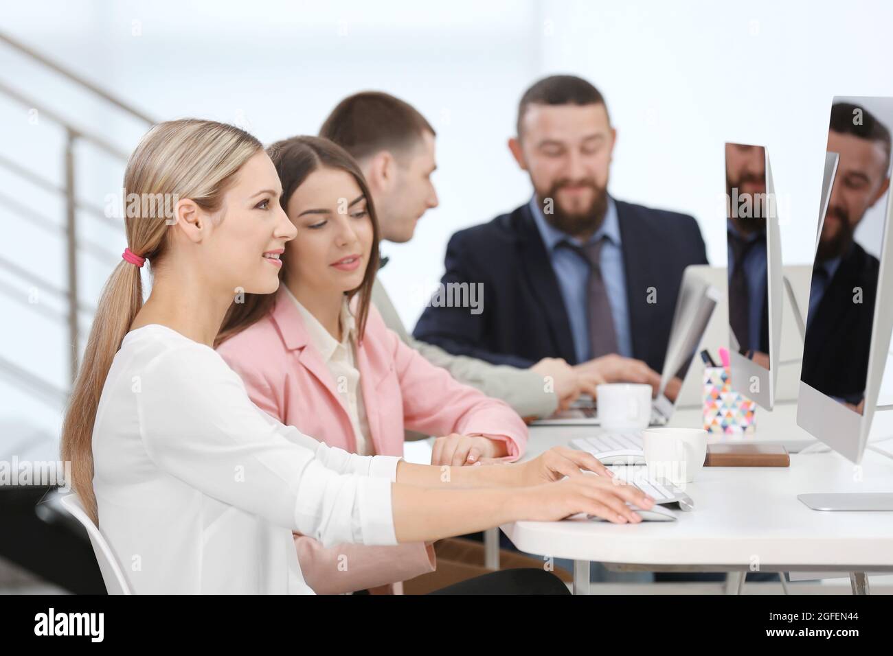 People working on computers at a office Stock Photo - Alamy