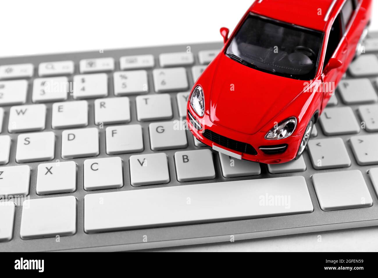 Red toy car on a keyboard Stock Photo - Alamy