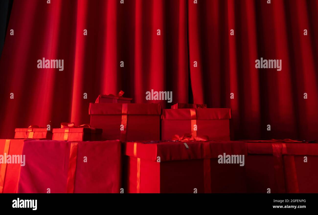 gifts on a background of red draped fabric Stock Photo - Alamy