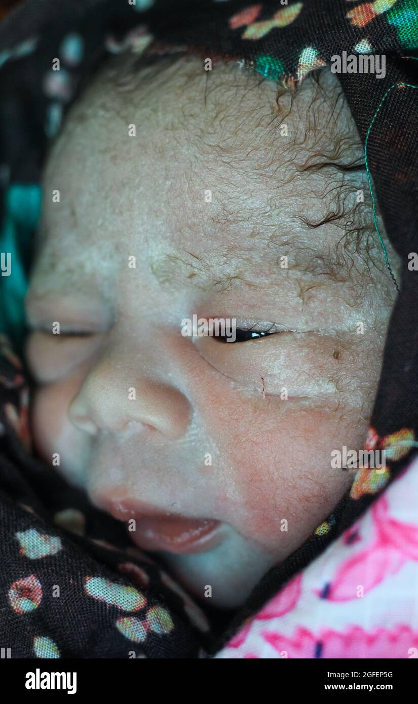 Beautiful baby boy a few seconds after the birth. Baby after birth ...