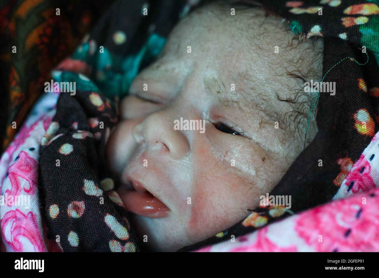 Beautiful baby boy a few seconds after the birth. Baby crying after ...