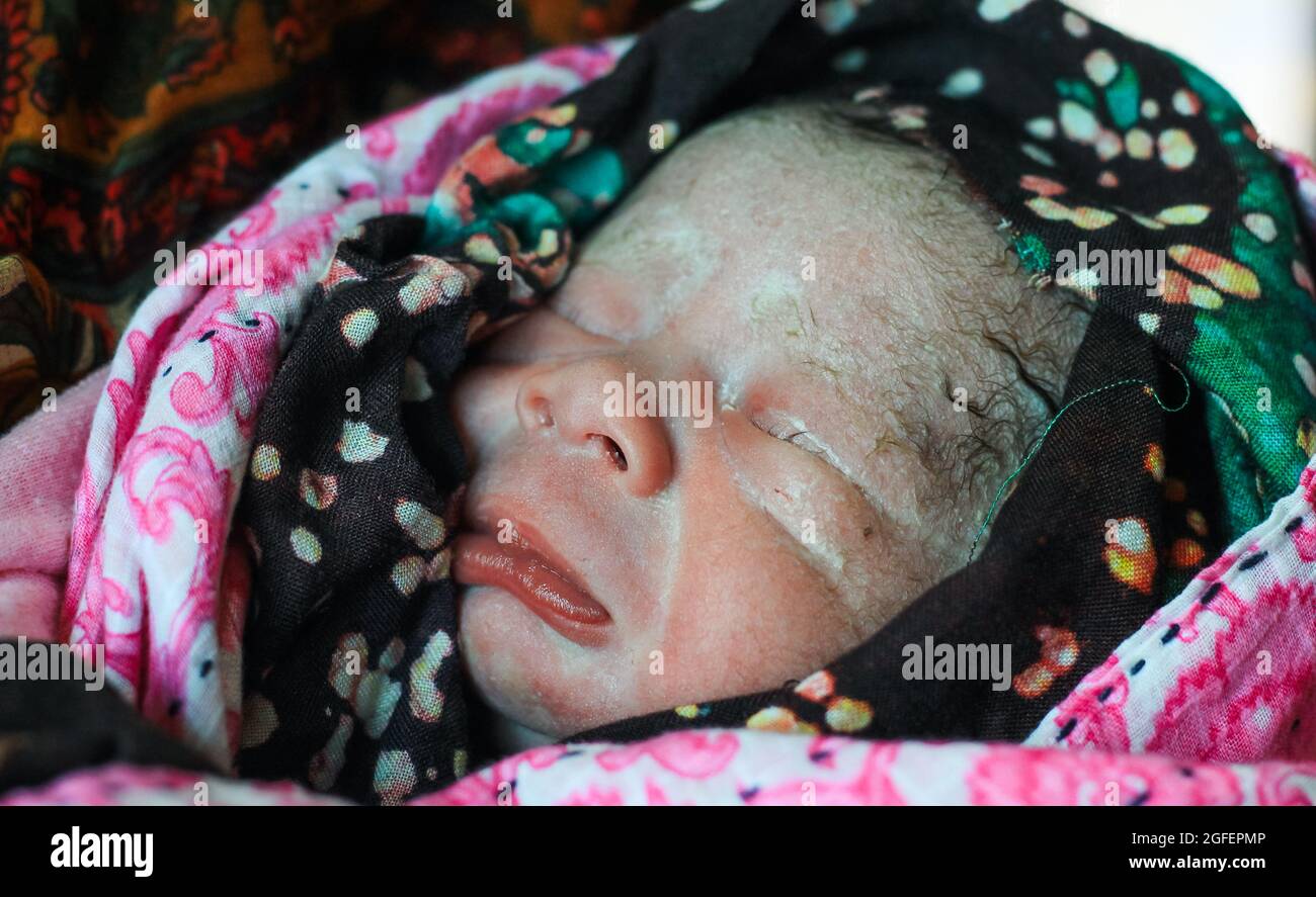 Beautiful baby boy a few seconds after the birth. Baby crying after ...