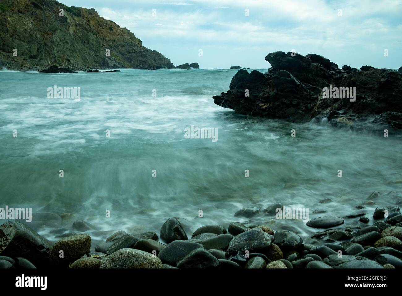 rocky beach landscape during storm with cloudy sky. Dramatic long ...