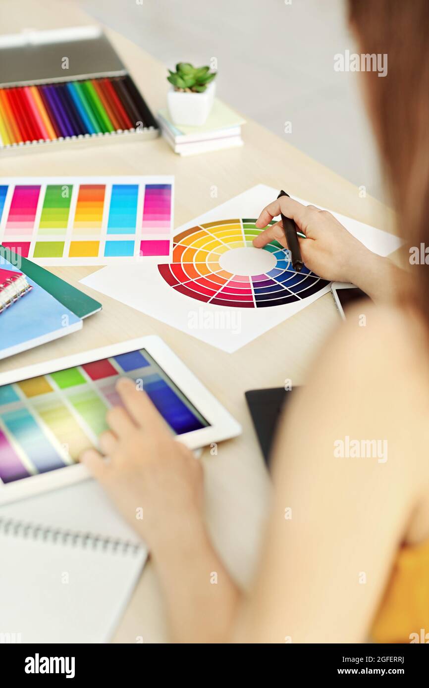 Designer workplace. Woman working with colour palette Stock Photo - Alamy